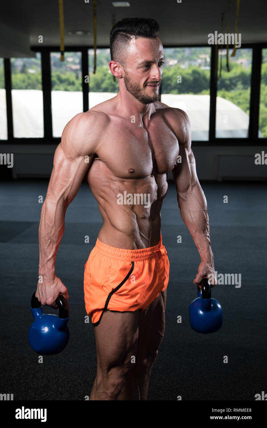 Man Exercising With Kettle Bell And Flexing Muscles - Muscular Athletic ...