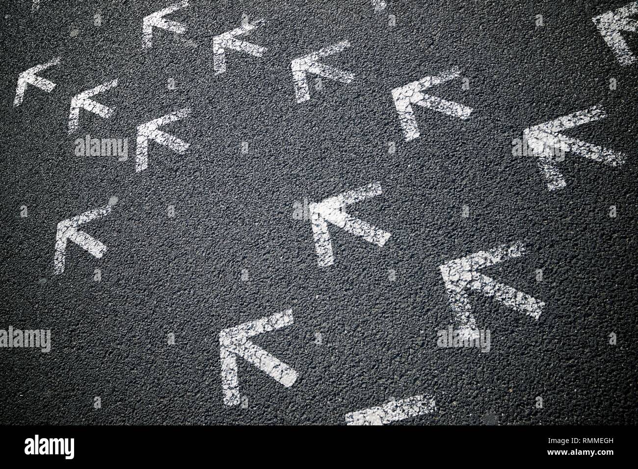 Directional arrows painted on a cement floor Stock Photo - Alamy
