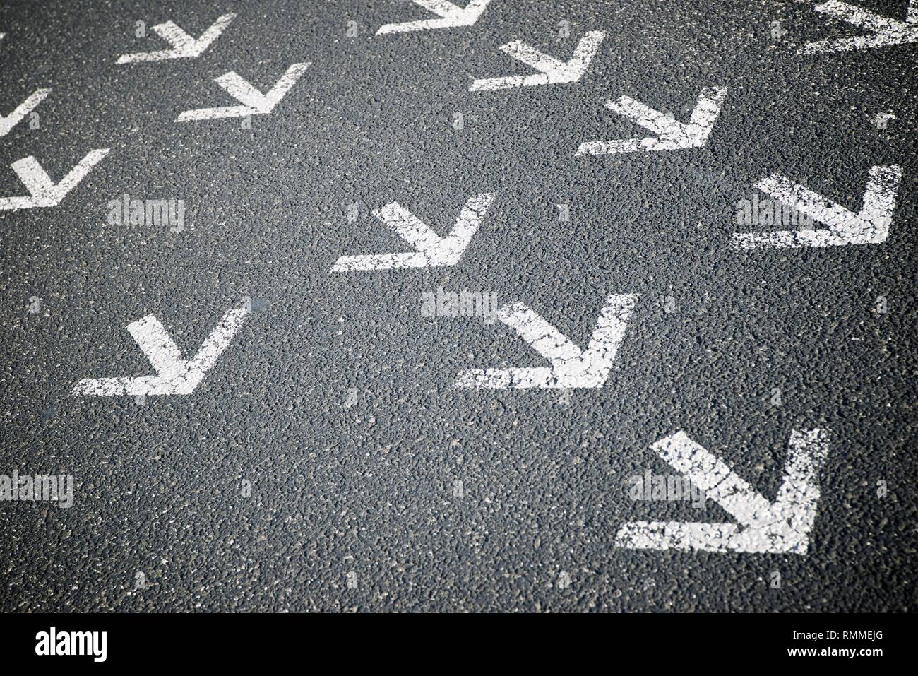 Directional arrows painted on a cement floor Stock Photo - Alamy