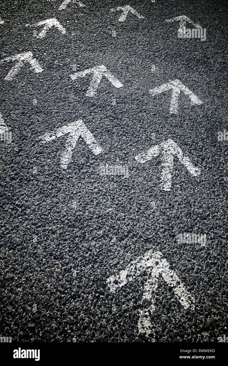 Directional arrows painted on a cement floor Stock Photo - Alamy