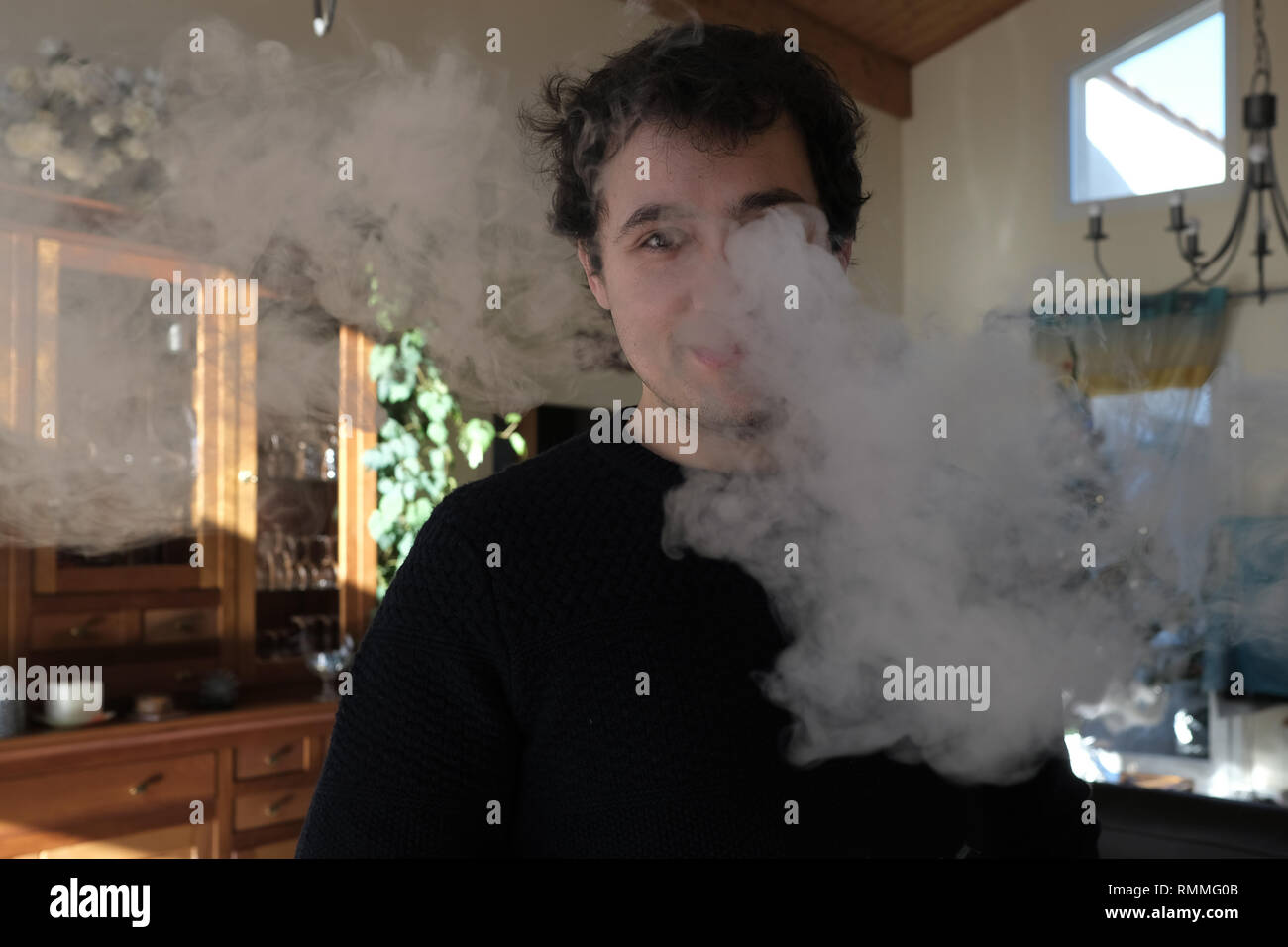 Blowing smoke in face hi-res stock photography and images - Alamy