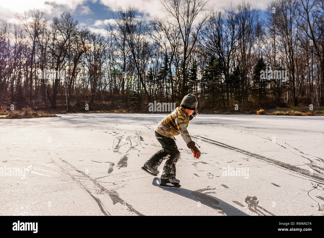 Boy ice-skating on a frozen lake, United States Stock Photo - Alamy