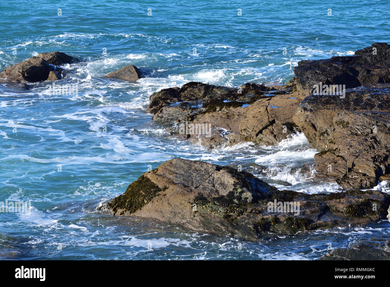 A calm sea with rocks Stock Photo - Alamy