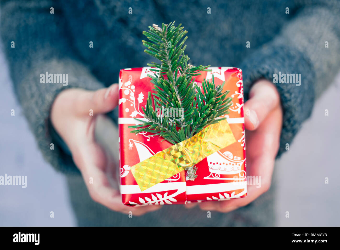 Boy holding a wrapped gift Stock Photo - Alamy