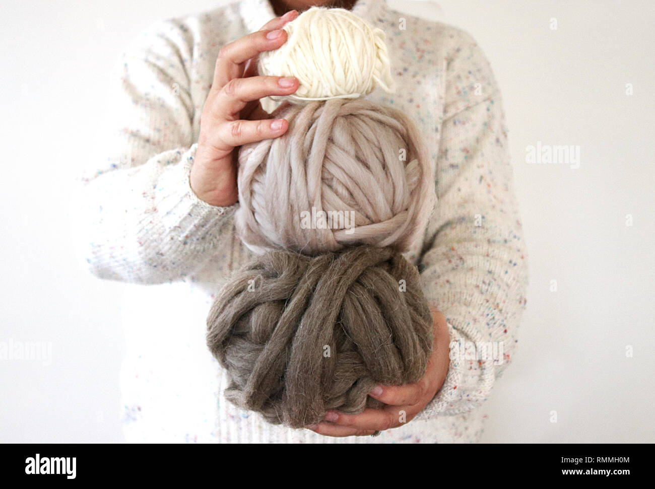 Woman holding balls of wool Stock Photo - Alamy
