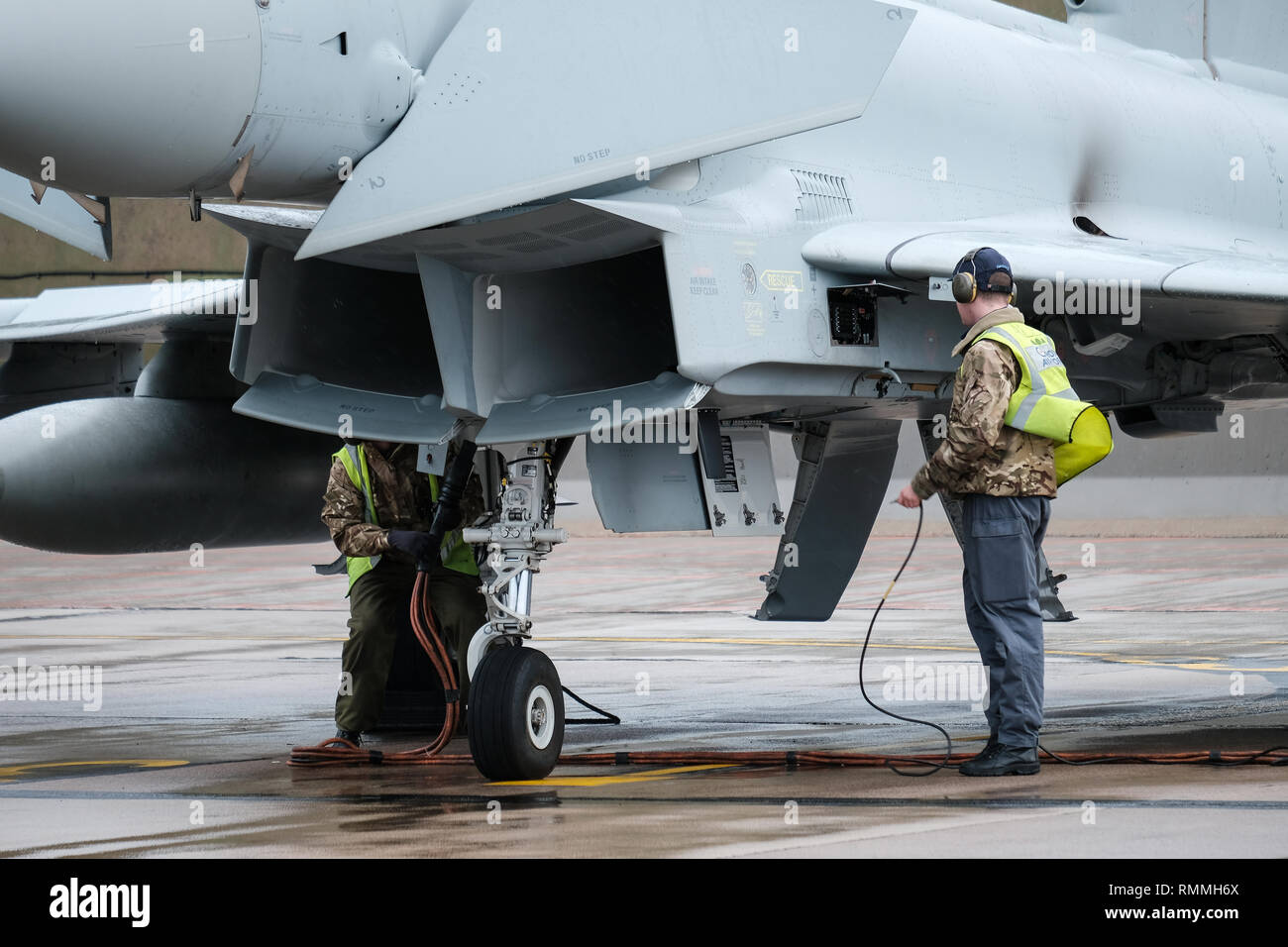 Ground crew conducting a pre-flight check over an RAF Tornado jet ...