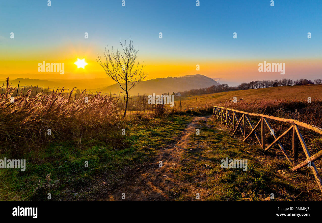 Footpath through a rural landscape at sunset, Gabicce Monte, Marche ...