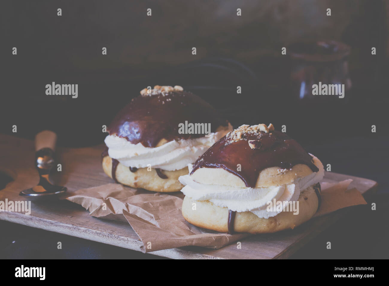 Cream filled bun with chocolate and chopped hazelnut Stock Photo - Alamy