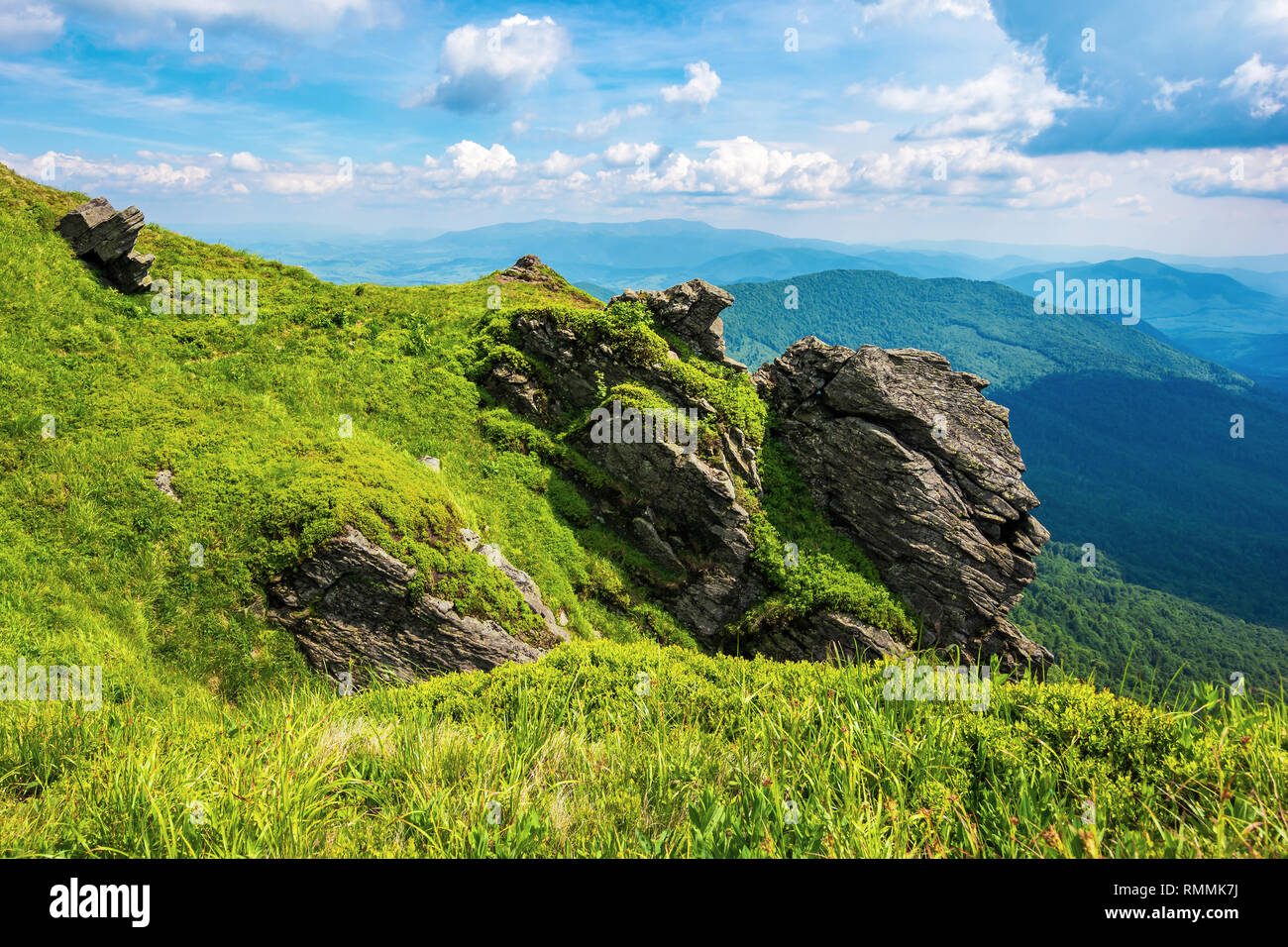 rocky cliff on a grassy slope. beautiful scenery in mountains. huge ...