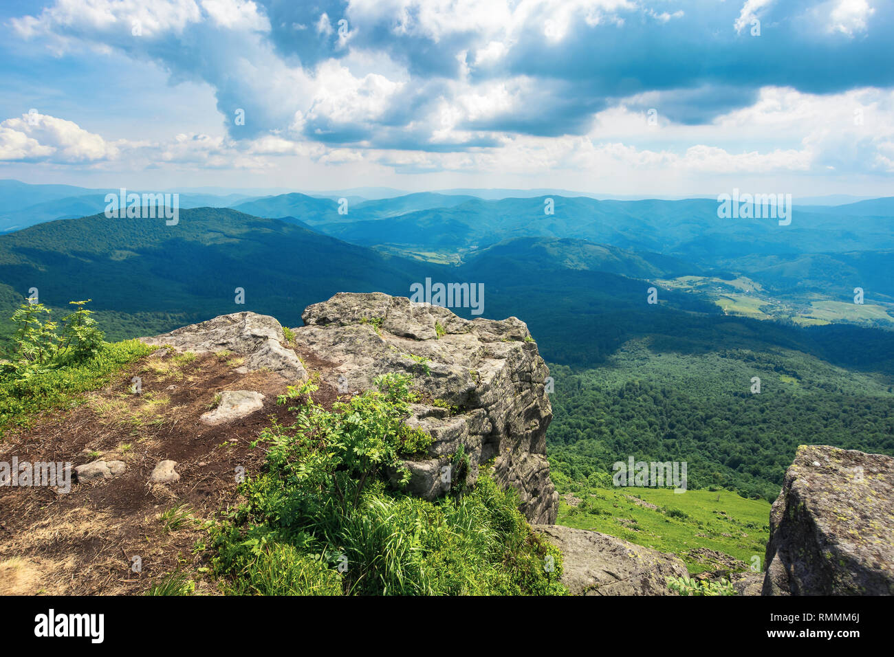 view from a rocky cliff in to the distant valley. beautiful summer ...