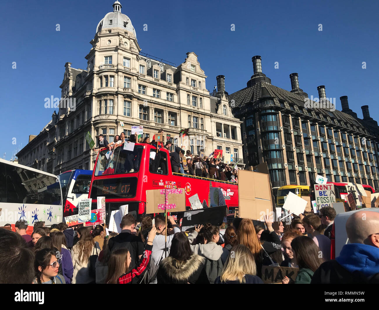 Students from the Youth Strike 4 Climate on an open top tourist bus ...