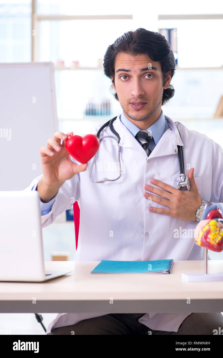 Young handsome doctor cardiologist in front of whiteboard Stock Photo ...