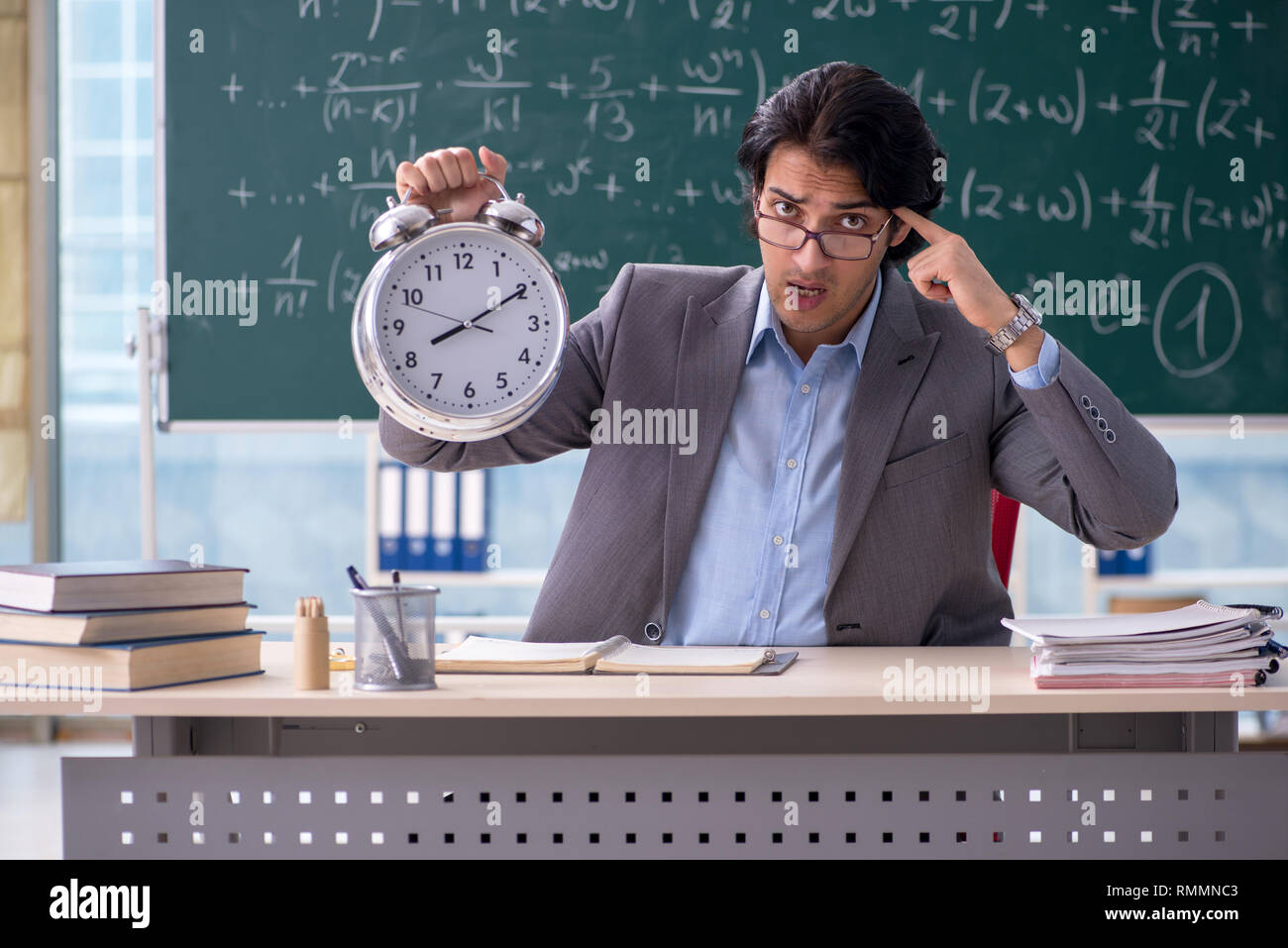 Young handsome math teacher in classroom Stock Photo - Alamy