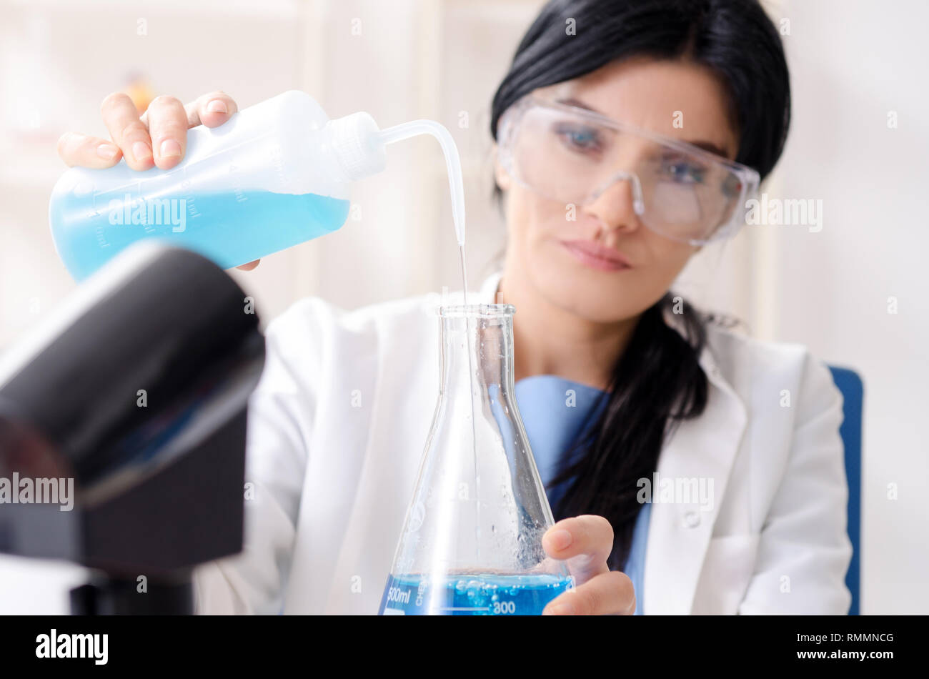 Female chemist working at the lab Stock Photo - Alamy