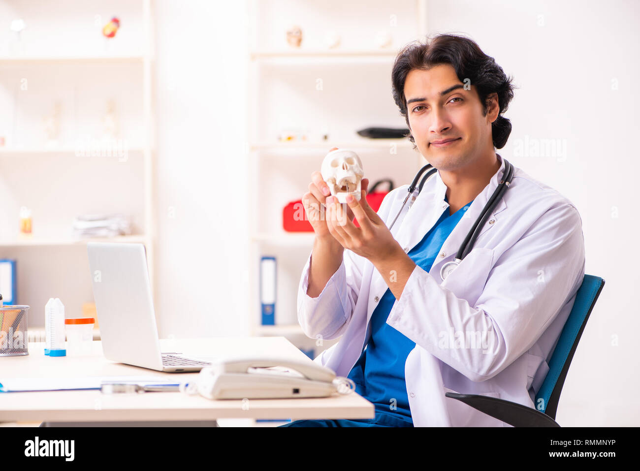 Young male doctor with human's skull Stock Photo - Alamy