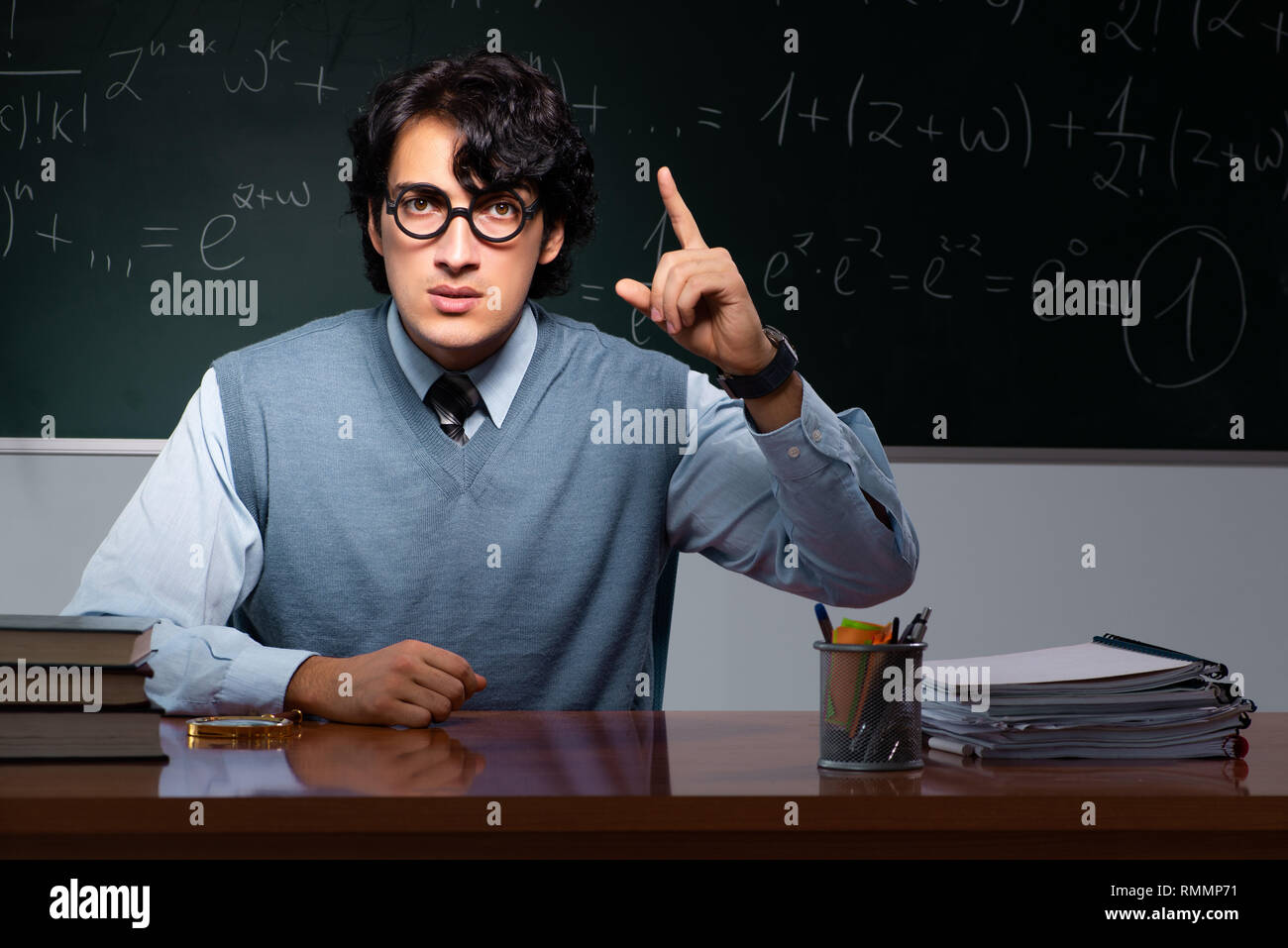 Young math teacher in front of chalkboard Stock Photo - Alamy