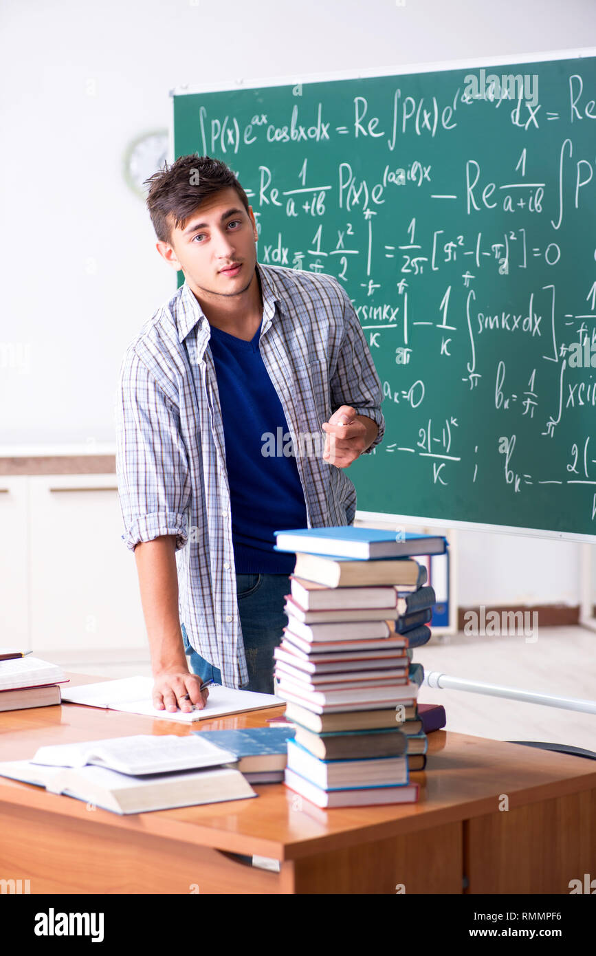 Young male student studying math at school Stock Photo - Alamy