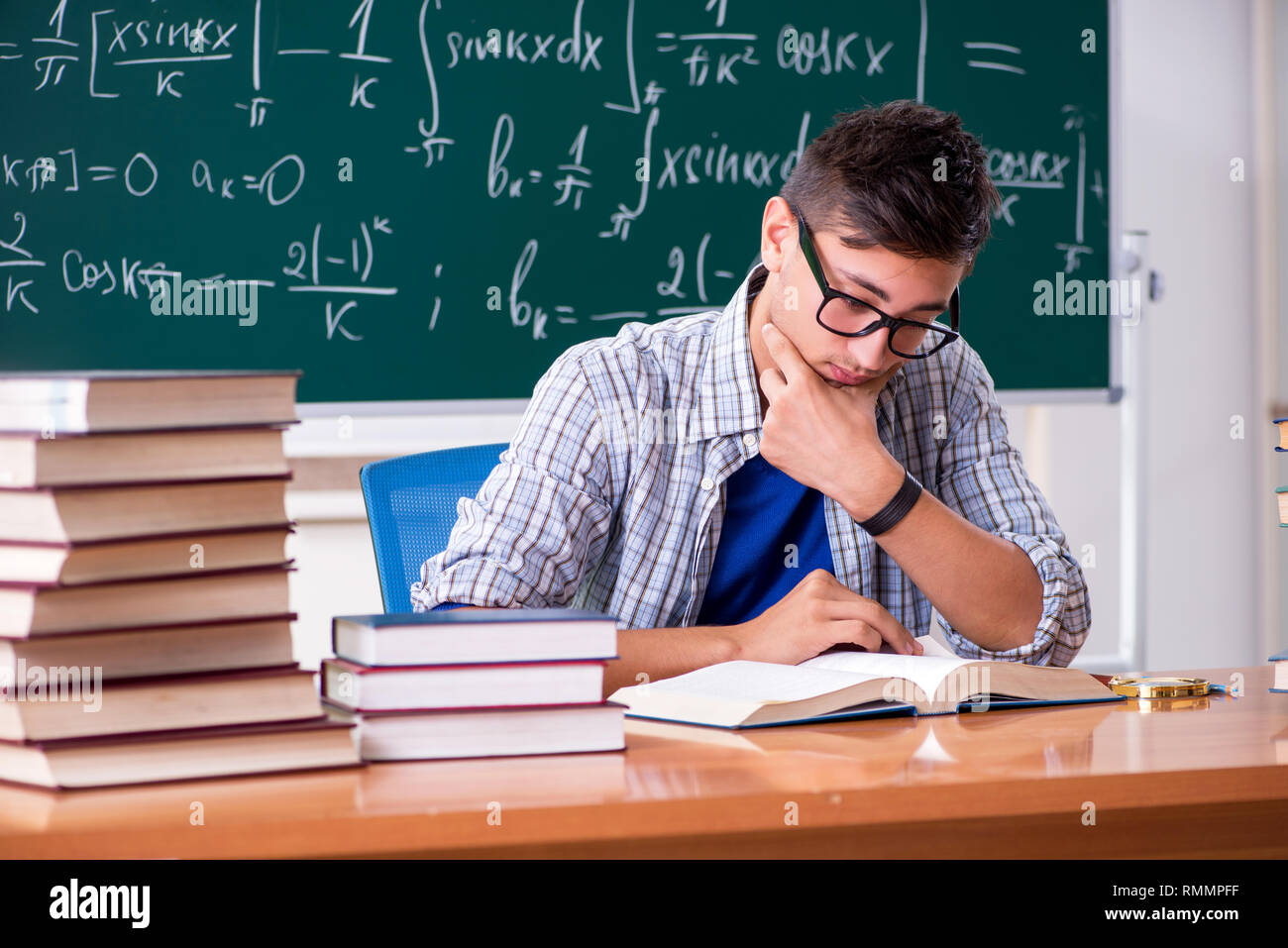 Young male student studying math at school Stock Photo - Alamy