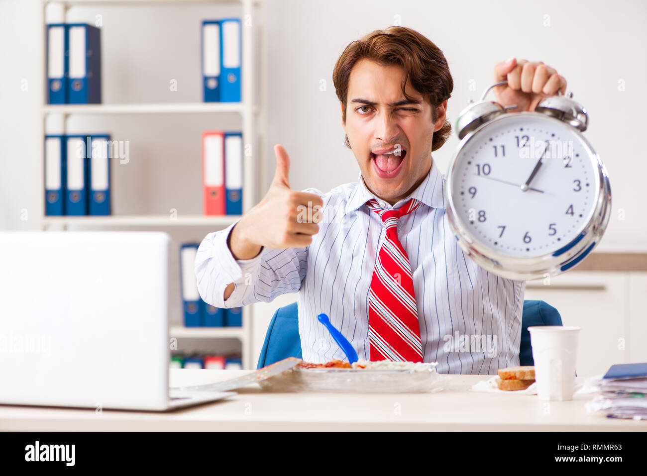 Man having meal at work during break Stock Photo - Alamy