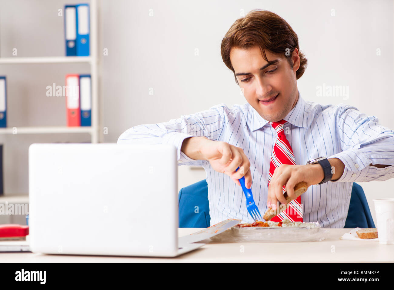 Man having meal at work during break Stock Photo - Alamy