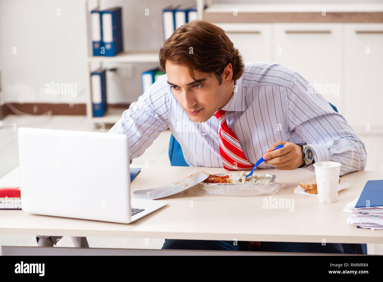 Man having meal at work during break Stock Photo - Alamy