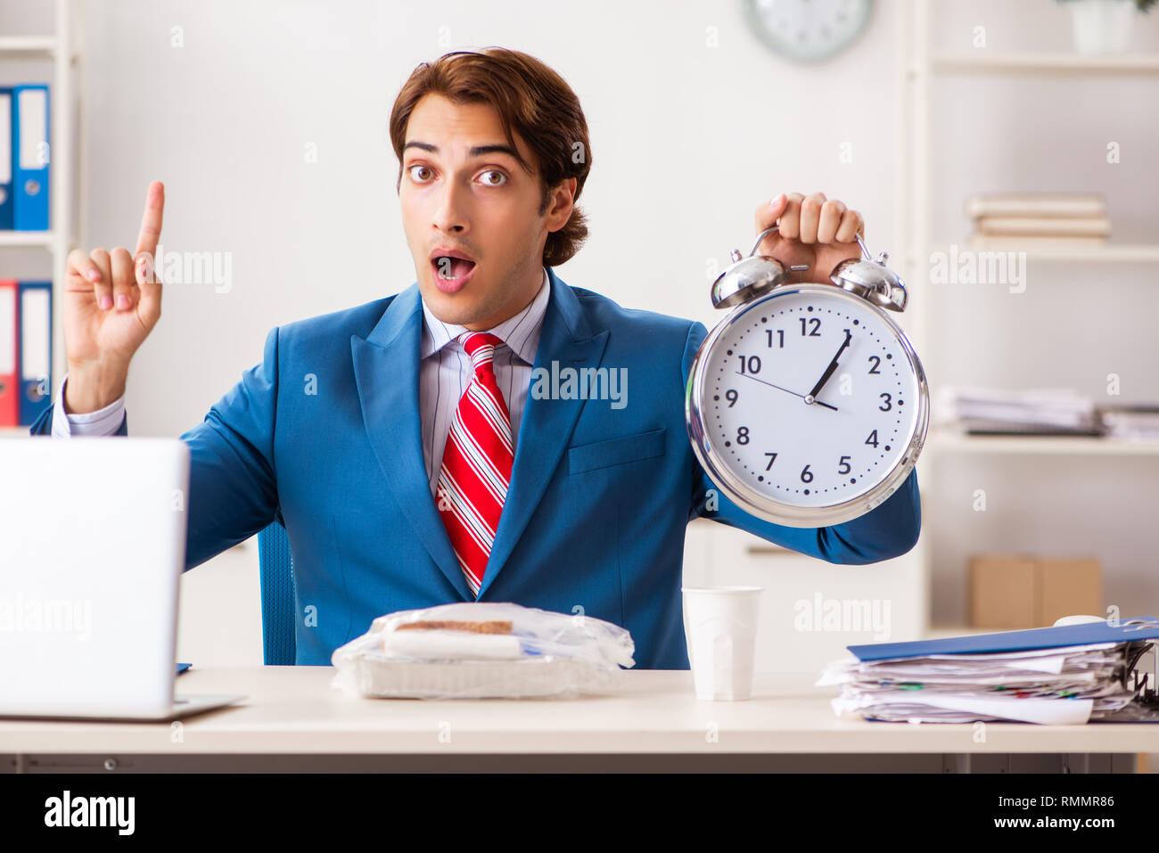 Man having meal at work during break Stock Photo - Alamy