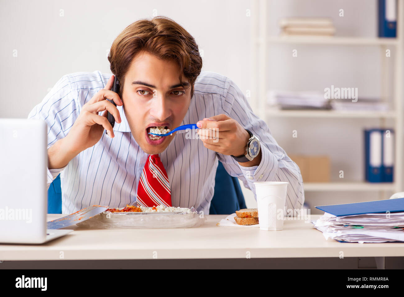 Man having meal at work during break Stock Photo - Alamy