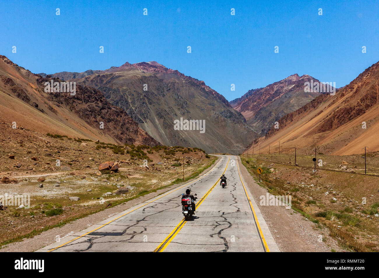 Two bikers on the National Route 7, here in the Andes, crosses ...