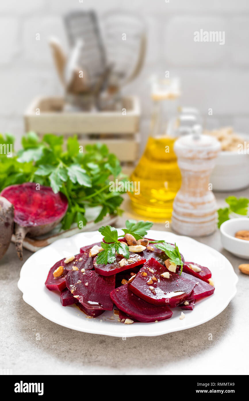 Vegetarian salad with boiled beet, almond nuts and oil. Healthy food ...