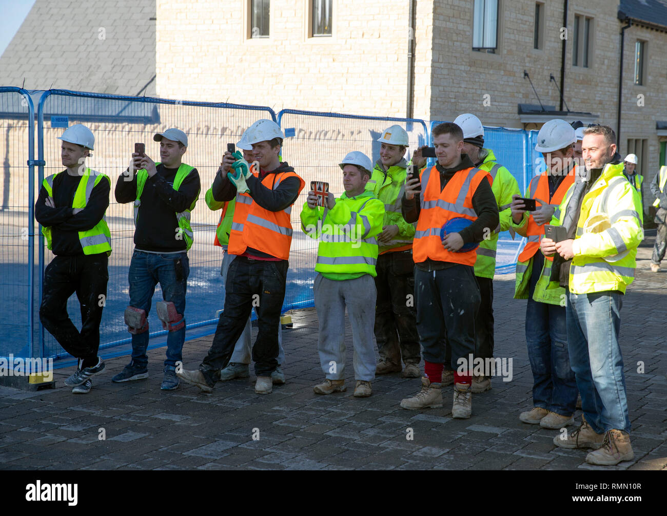 Builders wait to meet the Prince of Wales during a visit to ...