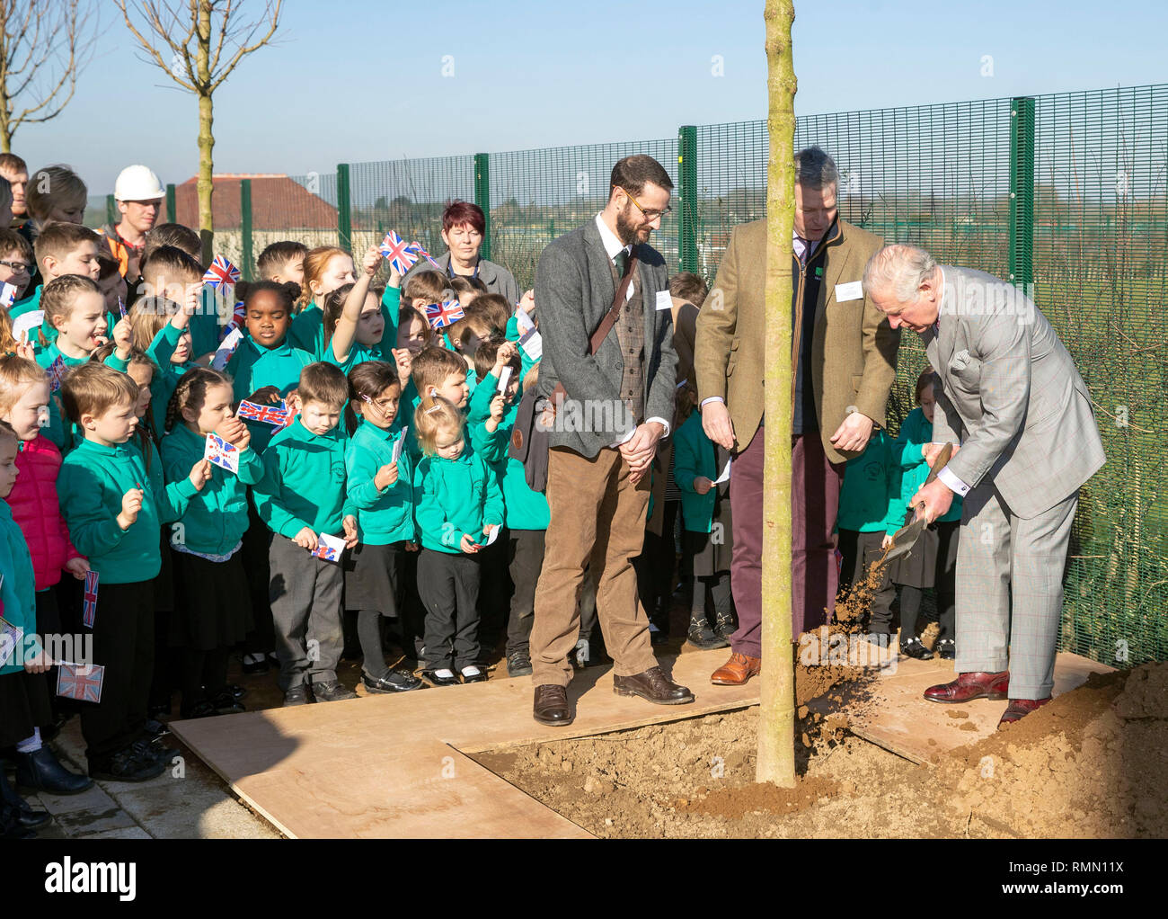 The Prince of Wales plants a tree during a visit to Bletchingdon ...