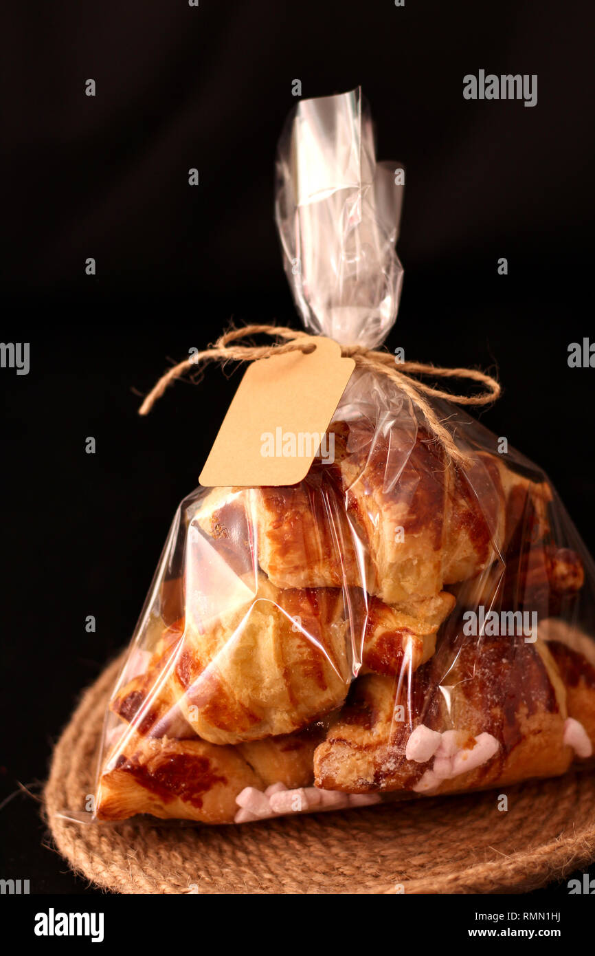 Fresh homemade French croissants with filling in a transparent ...