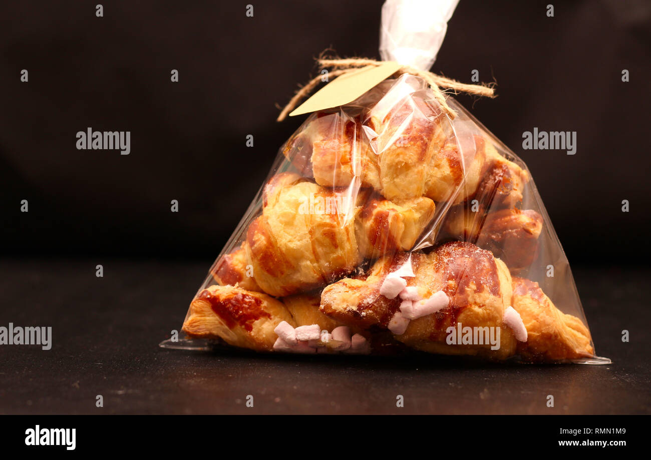 Fresh homemade French croissants with filling in a transparent ...