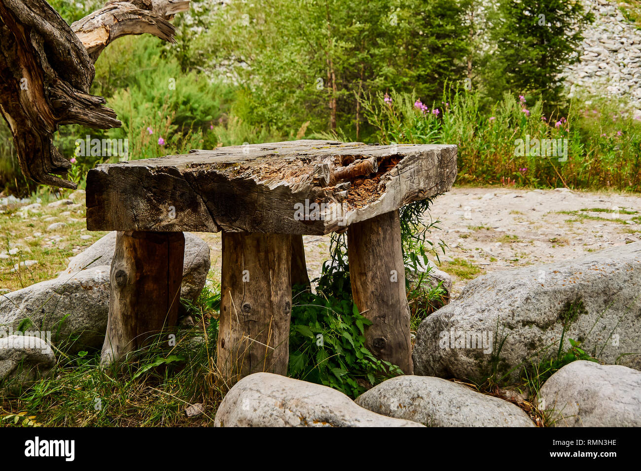 old table made of solid wood with stones, picnic area Stock Photo - Alamy