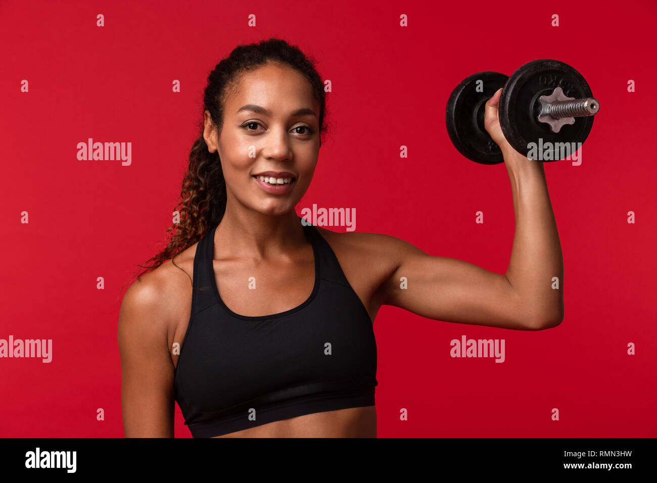 Image of a strong young african sports fitness woman posing isolated ...