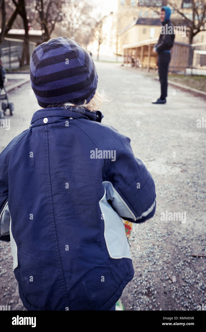 Rear view boy walking on hi-res stock photography and images - Alamy