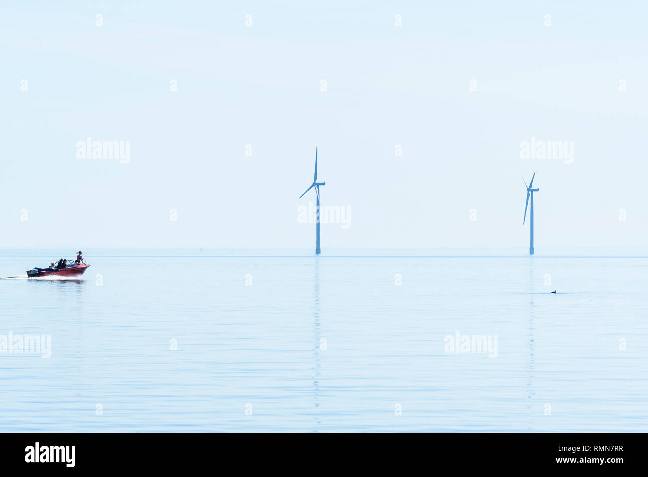 Boat on sea, wind turbines on background Stock Photo - Alamy