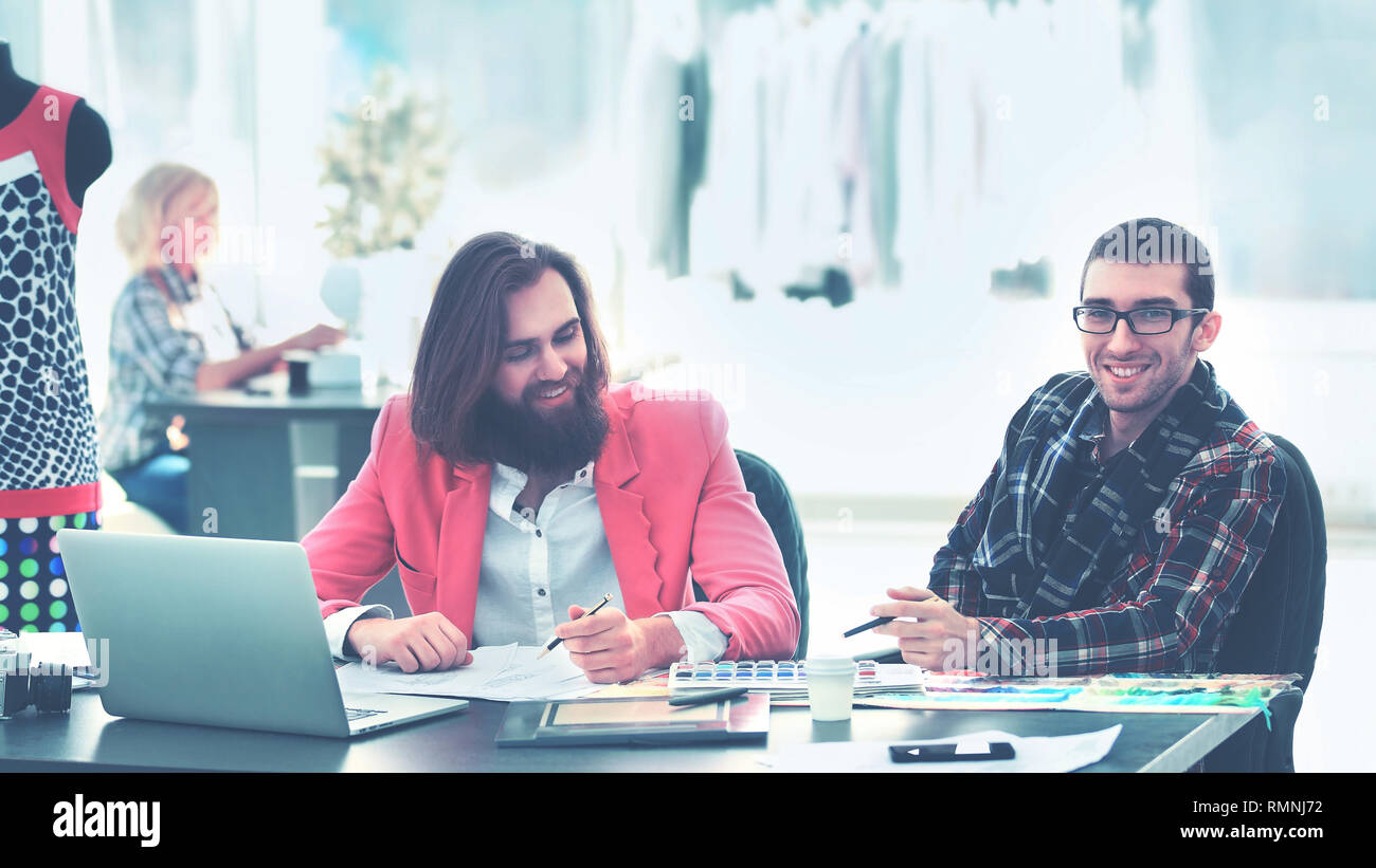 modern designer and his team is working on new models in apparel ...