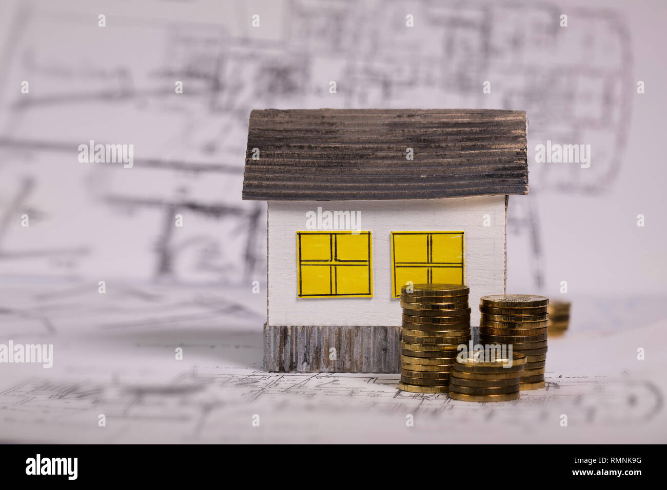 Small paper house on a technical drawing. Closeup Stock Photo - Alamy