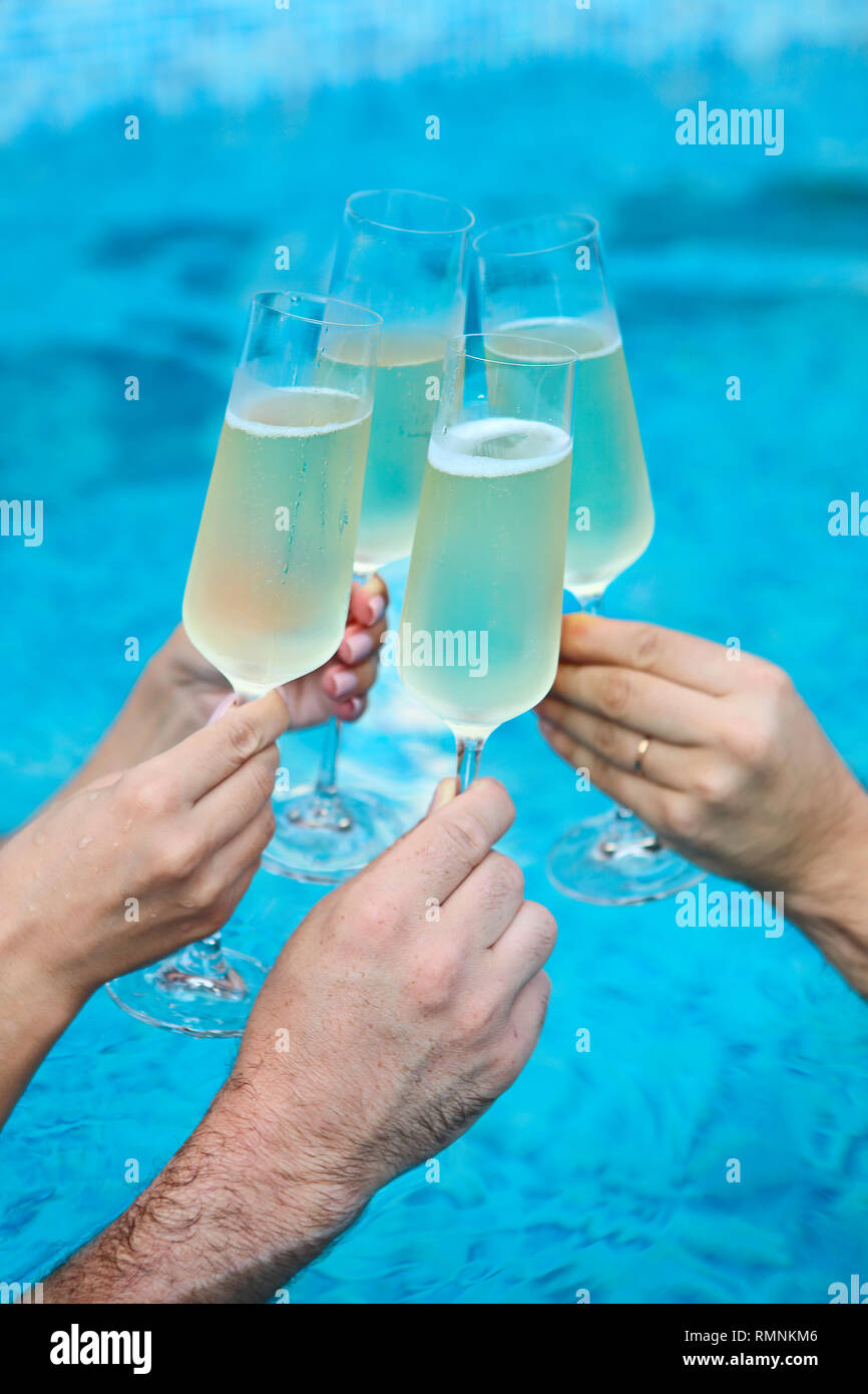 People hold champagne glasses in the pool. Summer pool party Stock ...