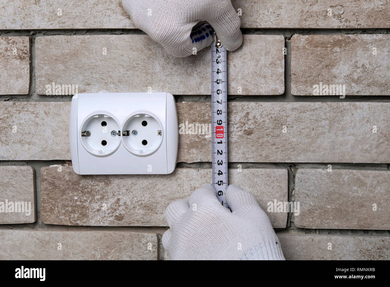 electrician installing sockets: home renovation and maintenance concept ...