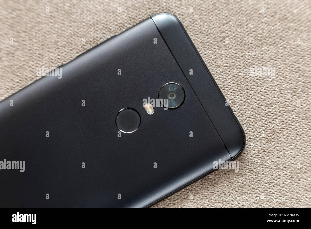 Back side of black cellphone isolated with security thumb fingerprint ...