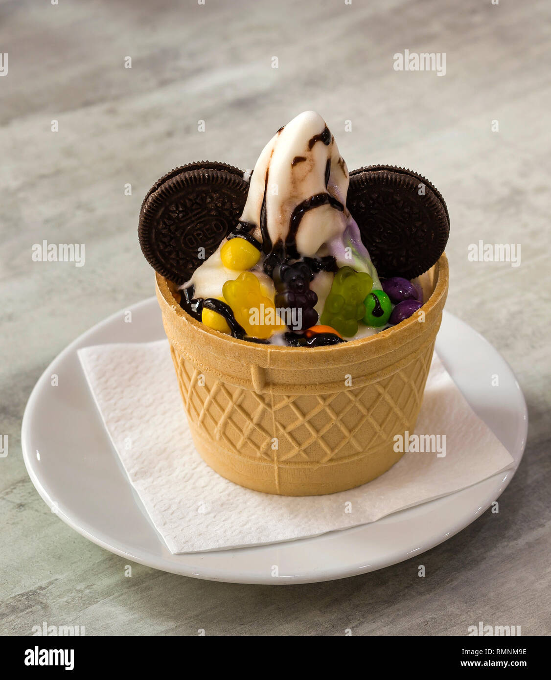 Ice cream dessert in wafer cup with chocolate cookies and creative ...