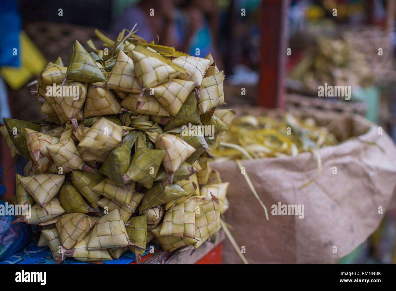 group of hanging rice, rice plaited in coconut leaves at a local street ...