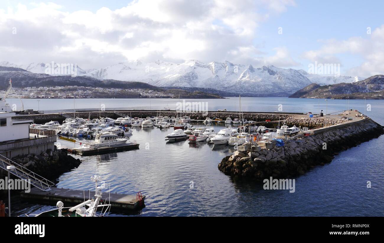 Arctic harbour scene with snow covered mountains behind, Norway Stock ...