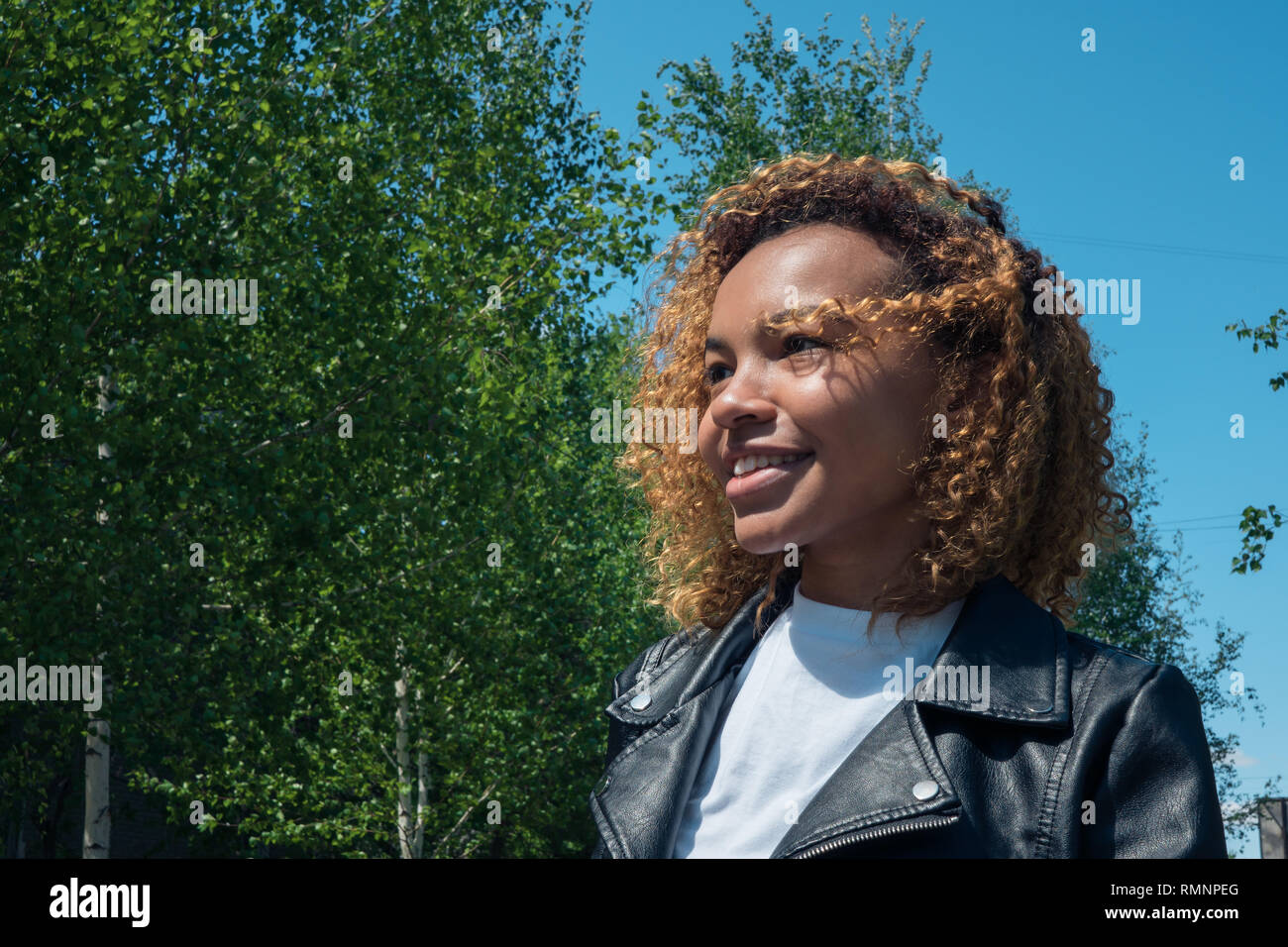 Beautiful african girl cute smiling in spring outside Stock Photo - Alamy