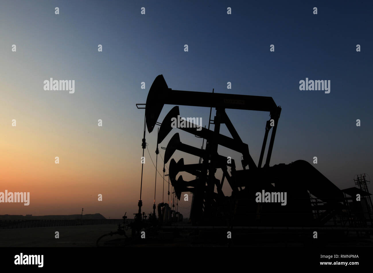 Oil pumps work in the desert oil fields of Sakhir, Bahrain. (Photo ...