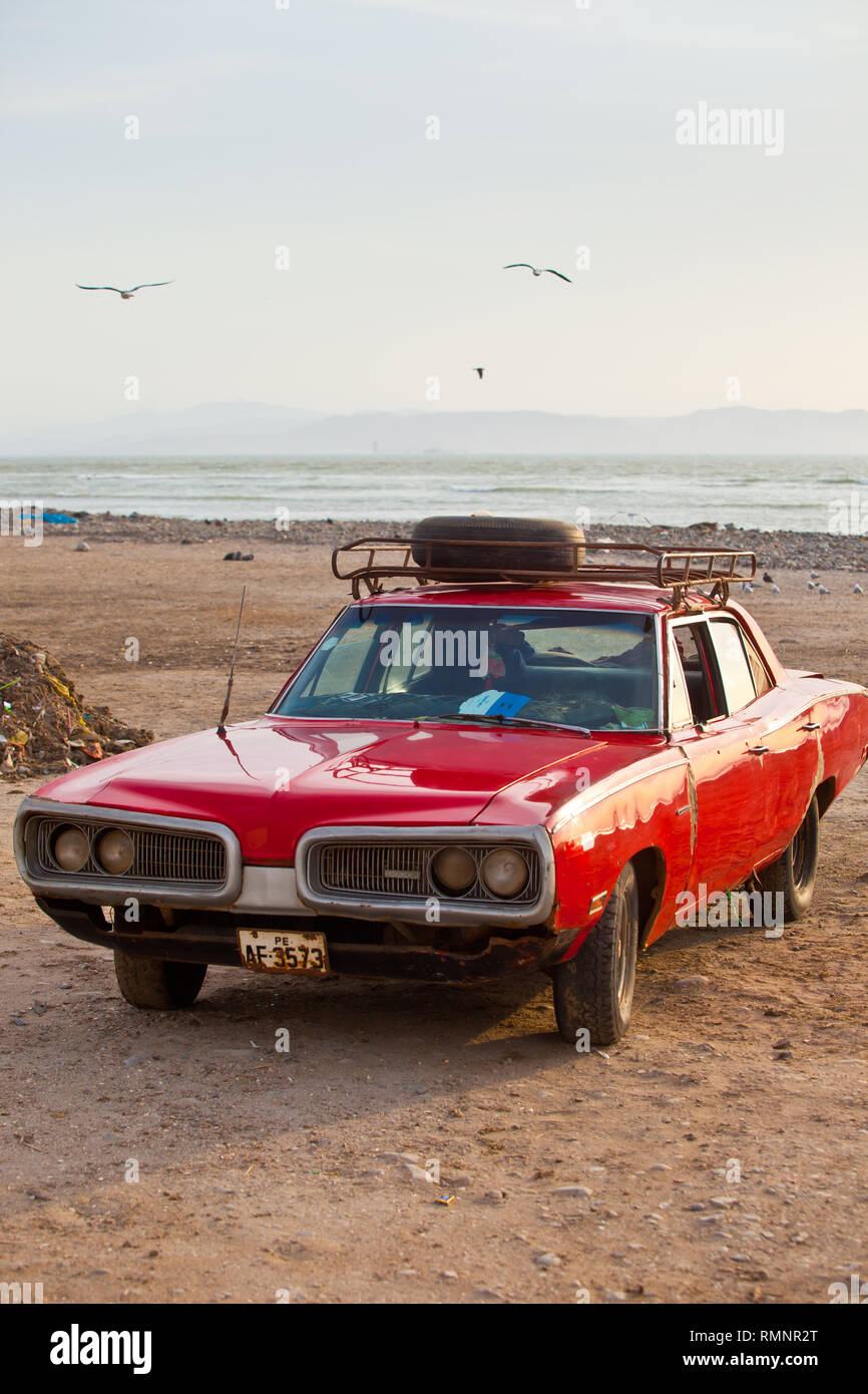 Red car in front of the ocean with a resting dog Stock Photo - Alamy
