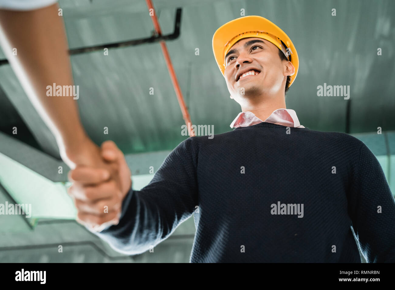 business deal. partner shaking hand. engineer with hardhat shake hand ...