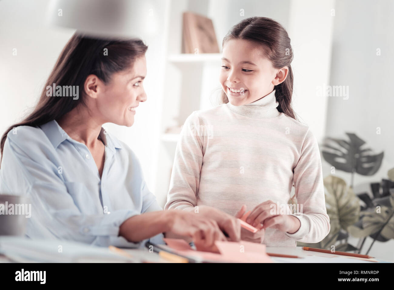 Parent guidance. Responsible young woman poking around paper sheets ...